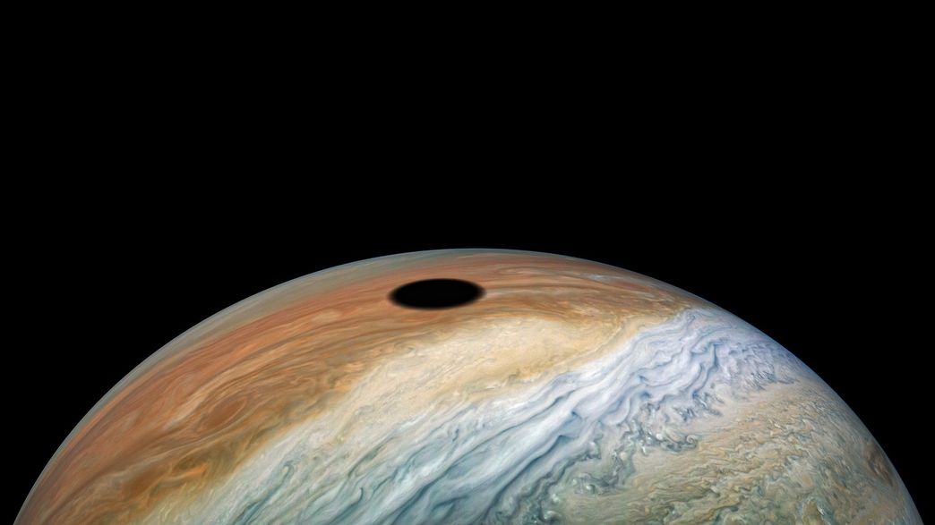 JunoCam Captures A Beautiful Solar Eclipse On Jupiter | IFLScience
